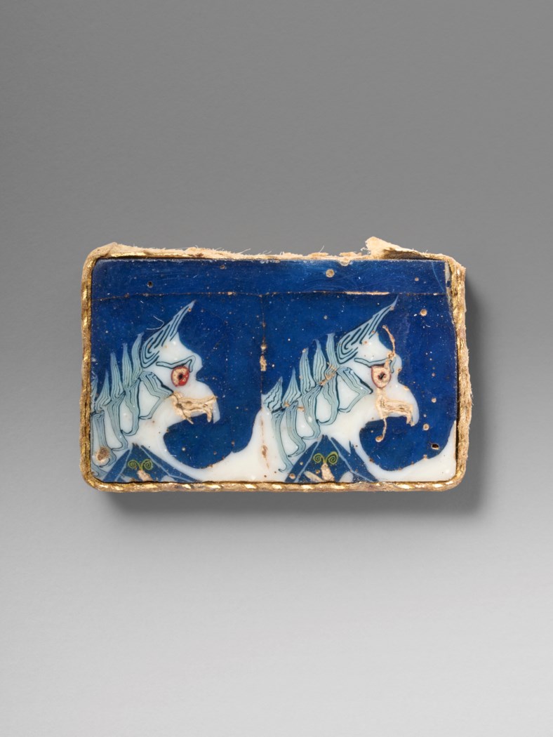 AN EGYPTIAN MOSAIC GLASS INLAY WITH TWO GRIFFIN HEADS, ROMAN PERIOD ...